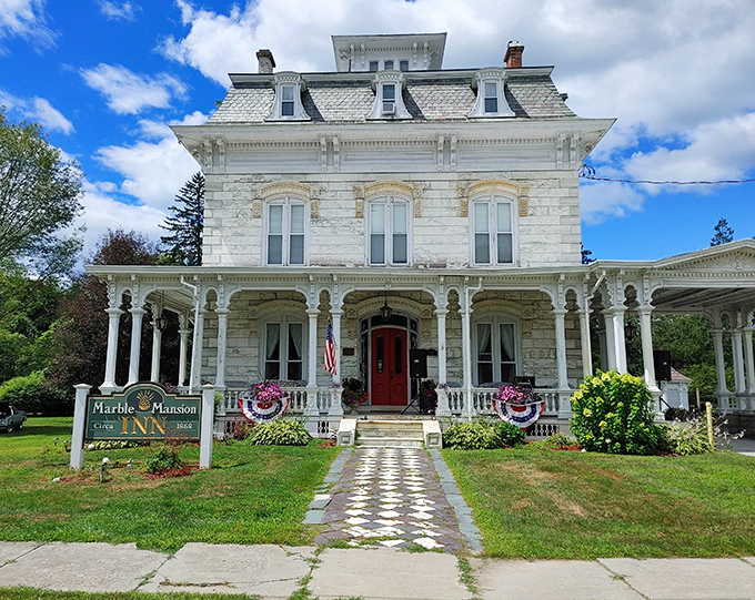 The Marble Mansion Inn stands like a wedding cake come to life, its pristine white facade and red door beckoning travelers to step back in time.