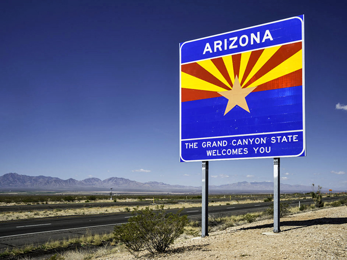 Welcome to Arizona isn't just a sign, it's a promise. This sun-drenched gateway beckons you to a land where adventure is as abundant as cacti. Photo credit: NPR