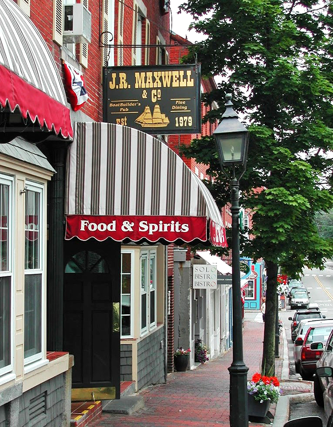 The iconic J.R. Maxwell & Co. sign stands proud against red brick, promising fine dining and maritime charm since 1979.