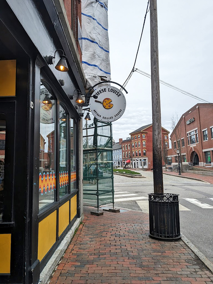 A cheerful yellow-and-black storefront beckons cheese lovers into this Portland gem, where comfort food meets culinary creativity. Photo credit: Carey Zhuang