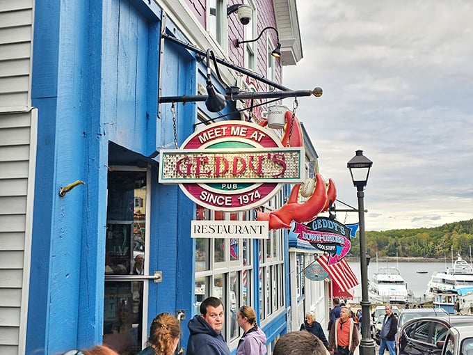 The iconic blue-trimmed entrance of Geddy's has been welcoming hungry visitors to Bar Harbor since 1974, complete with a playful lobster sign that seems to wink at passersby. Photo credit: Christopher Tucker