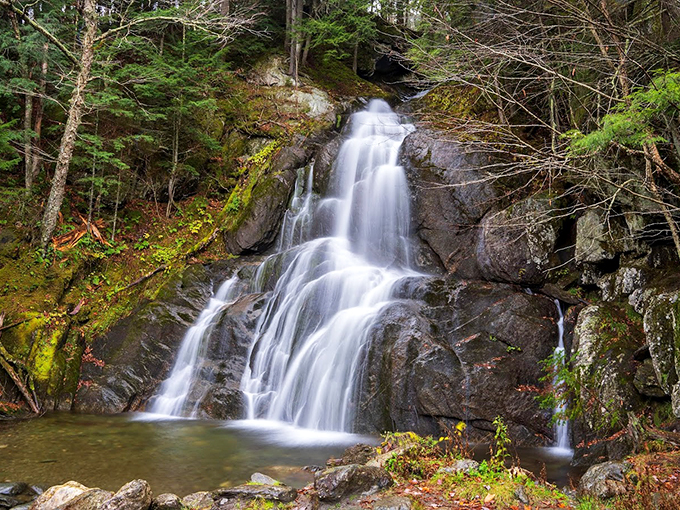 Nature's own infinity pool! Warren Falls cascades down smooth rock faces, creating a mesmerizing dance of white foam and mist.