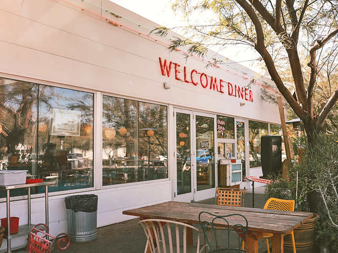 The Welcome Diner's vintage-style signage and desert landscaping create an inviting oasis in Phoenix's urban landscape.
