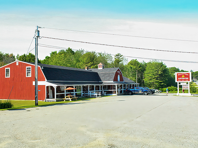 A classic red New England barn transformed into a treasure hunter's paradise. The covered porch welcomes visitors like an old friend's embrace.