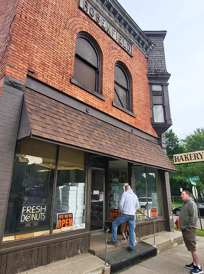 A century-old brick fortress of flavor! Hinkley Bakery stands proud, its "Fresh Donuts" sign a beacon of hope for carb-lovers everywhere.