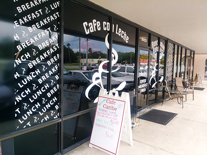 Welcome to flavor town! Cafe Caribe's storefront promises a Cuban culinary adventure that'll make your taste buds salsa dance with joy. Photo credit: Alex Perfecto