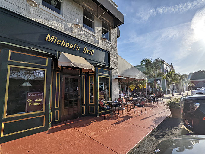 Welcome to flavor town! Michael's Grill beckons with its charming facade and inviting outdoor seating. This unassuming spot might just be Tampa's best-kept culinary secret. Photo credit: Maria Hidalgo Dolan