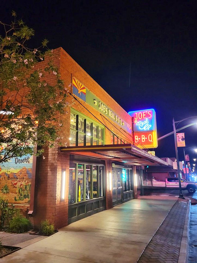Joe's Real BBQ lights up the night in Gilbert, Arizona, with its inviting neon sign and charming brick facade - a beacon for barbecue lovers and hungry night owls alike.