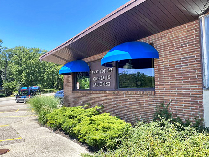Blue awnings and brick walls: The What-Not-Inn's exterior is like a warm hug from your favorite aunt &ndash; inviting, unpretentious, and promising comfort food that'll make your taste buds dance.