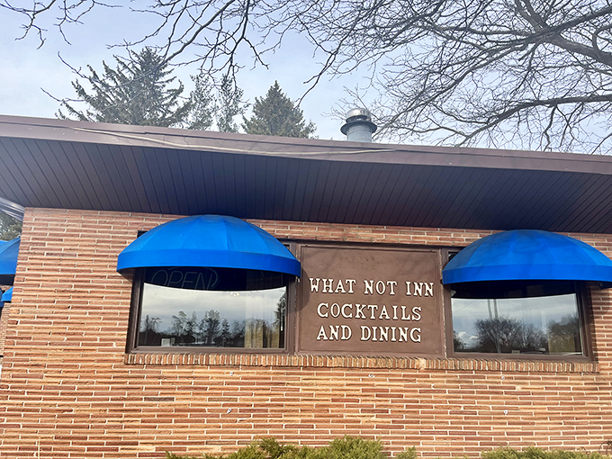 Blue awnings and brick walls: The What-Not-Inn's exterior is like a warm hug from your favorite aunt &ndash; inviting, unpretentious, and promising comfort food that'll make your taste buds dance.