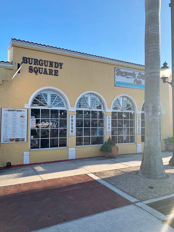 Welcome to flavor paradise! Burgundy Square Cafe's sunny exterior promises a feast for the senses, with arched windows inviting you into a world of culinary delights. Photo credit: Jeff Smith