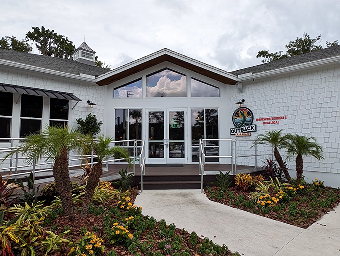 Welcome to seafood paradise! The Outback Crab Shack's inviting exterior promises a feast for the senses, with lush landscaping that's more "tropical oasis" than "tourist trap." Photo credit: Sue Minter