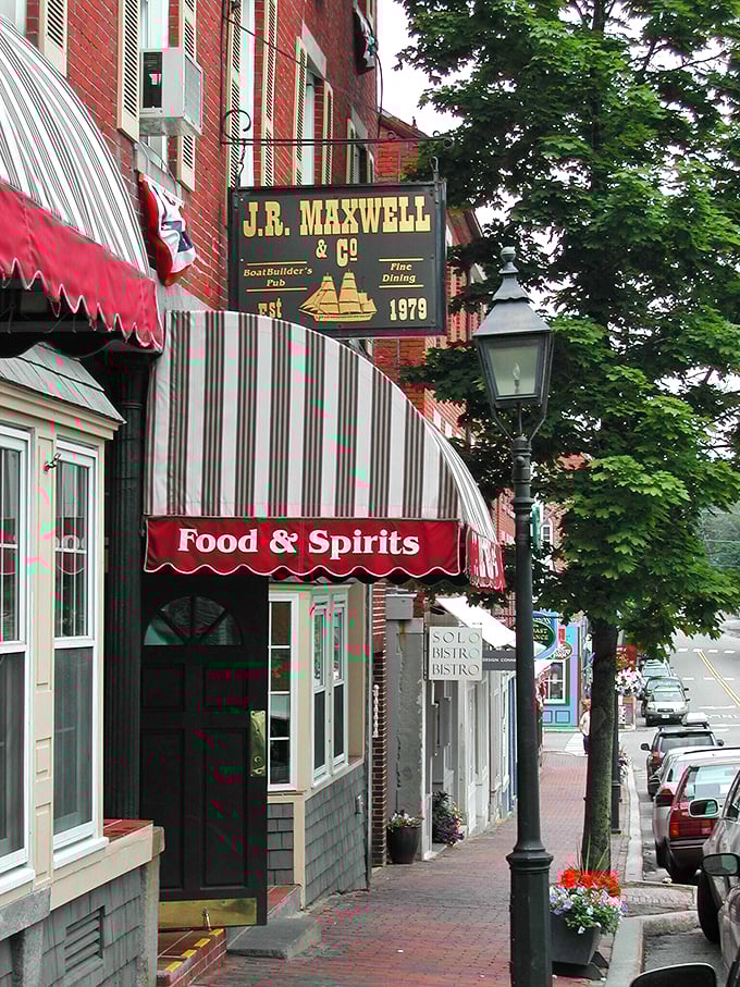 Ahoy, seafood lovers! J.R. Maxwell & Co. stands like a beacon of culinary delight, its red brick exterior and striped awning promising maritime marvels within.