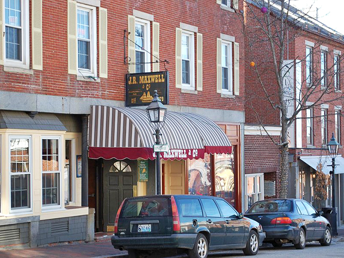 Ahoy, seafood lovers! J.R. Maxwell & Co. stands like a beacon of culinary delight, its red brick exterior and striped awning promising maritime marvels within.