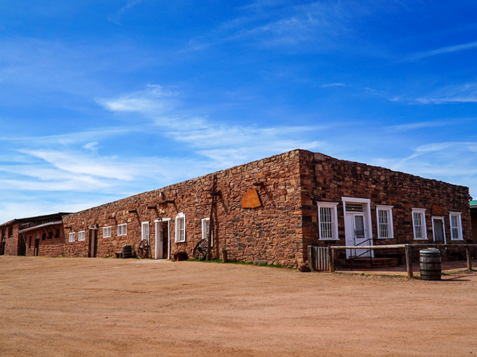 The Hubbell Trading Post stands as a timeless sentinel of the Old West, its sturdy stone walls and weathered facade a testament to over 140 years of history under the vast Arizona sky.