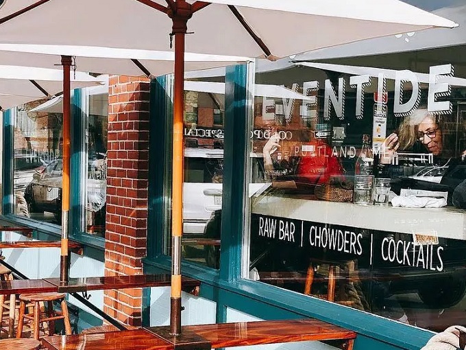 A seafood lover's dream come true! Eventide's turquoise exterior and cozy outdoor seating invite you to dive into a world of oceanic delights.