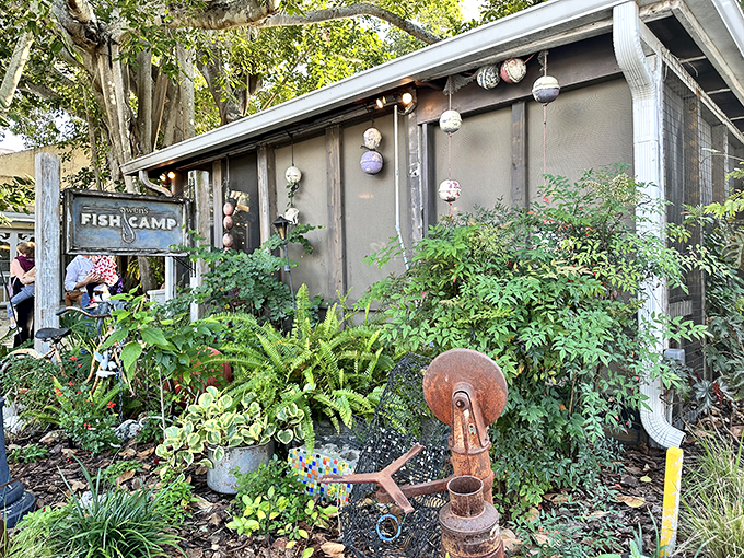 Welcome to seafood paradise! Owen's Fish Camp's exterior is a whimsical blend of coastal charm and jungle-like foliage, inviting you to embark on a culinary adventure.