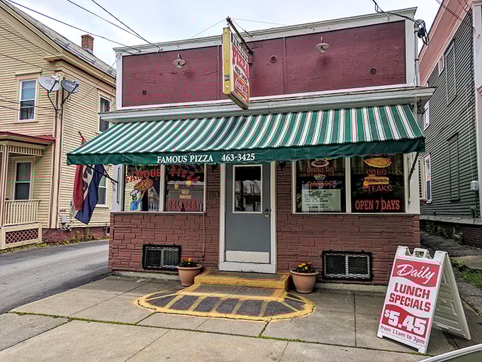 A slice of Americana! This charming brick facade with its jaunty green awning promises comfort food that'll make you feel right at home.