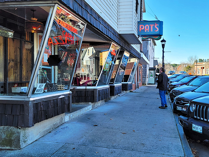 Neon dreams and pizza schemes! Pat's iconic sign beckons like a lighthouse for the hungry, promising a slice of Orono history with every bite.