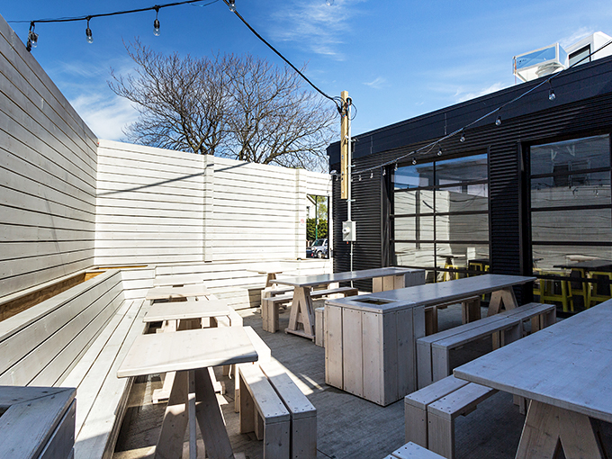 Sleek meets street art! Kimski's exterior is like a cool kid's treehouse got a modern makeover and decided to serve amazing food.