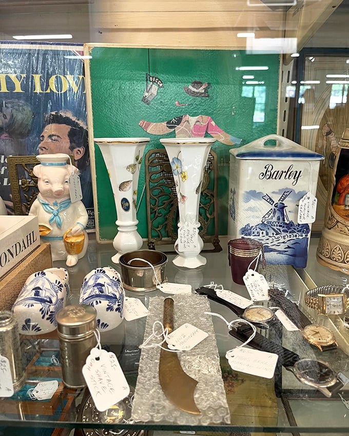 From vintage Barley canisters to whimsical figurines, this display case is a time machine of everyday treasures.