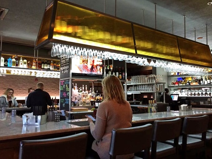 The bar's golden glow and sparkling glassware create an ambiance that says "your martini will be perfect tonight."