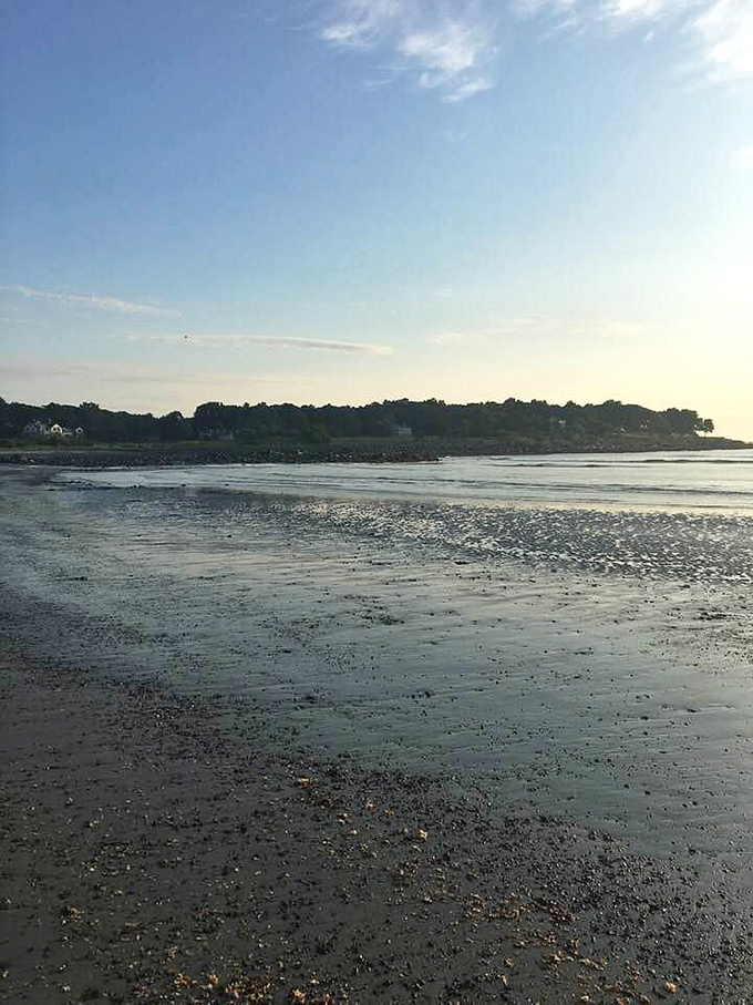 Low tide reveals nature's artwork along Kittery's shoreline, where sky meets sea in a peaceful coastal tableau.