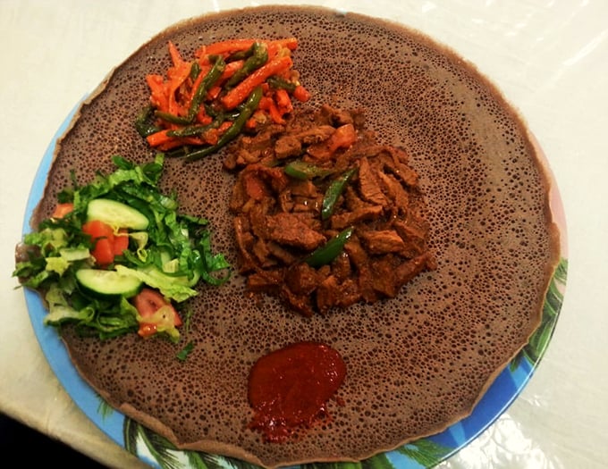 A symphony of spices dances through tender beef, while fresh salad adds a cooling counterpoint to this traditional dish.