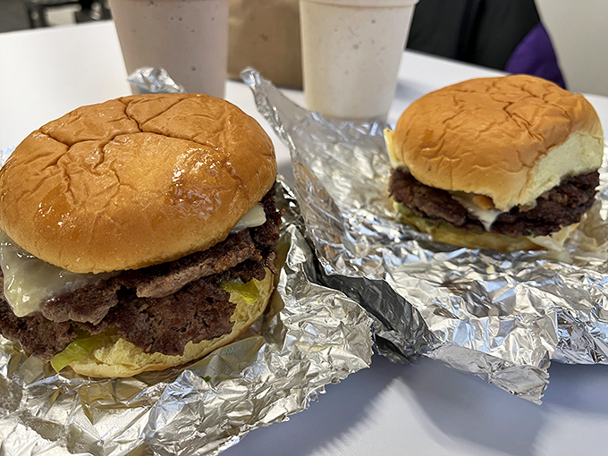 Two burgers that look like they just stepped out of a food photographer's dream, complete with perfectly toasted buns.