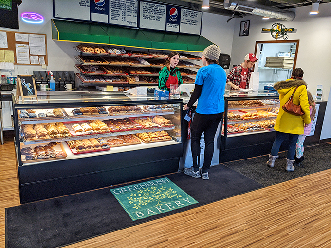 Happy customers pondering life's greatest question: "Which donut should I choose?" It's a delicious dilemma!