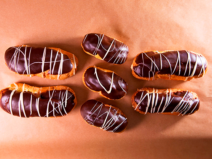 These chocolate eclairs aren't just desserts - they're edible works of art drizzled with white chocolate personality. Photo credit: Beach Pea Baking Co