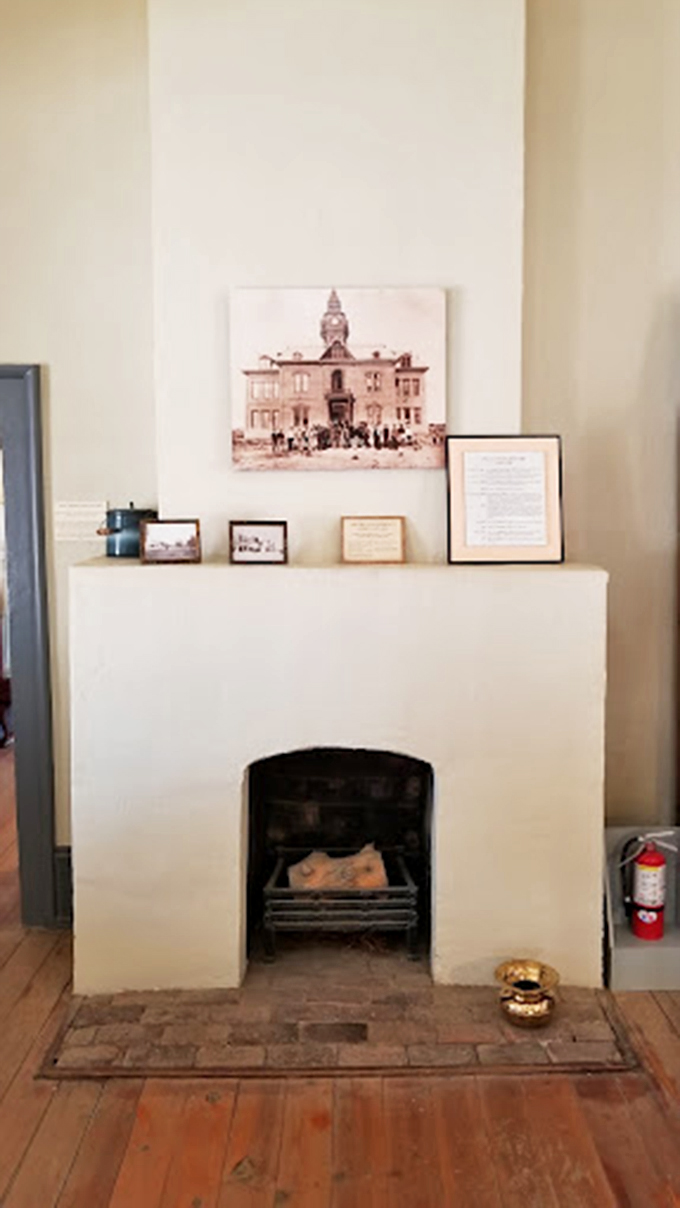 The original fireplace stands as a silent witness to history, its weathered brick telling tales of winters past.