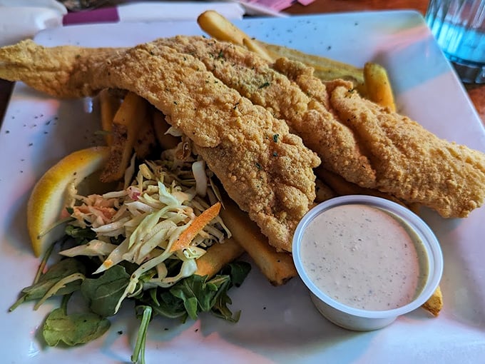 Golden-battered fish fillets that would make Neptune himself proud, served with a fresh slaw and crispy fries. Photo credit: Aaron N
