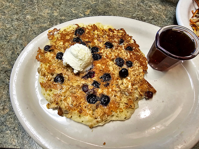 A granola pancake that's trying to be healthy, but can't resist the siren call of blueberries and whipped cream. It's the breakfast version of your friend who says they're on a diet, then orders dessert. Photo credit: Tim Askelson