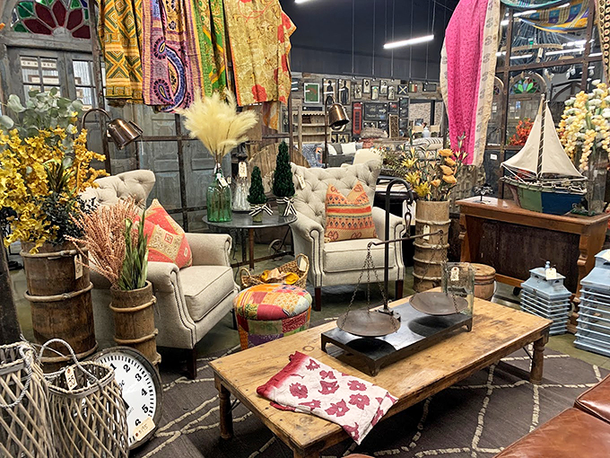 Bohemian rhapsody in furniture form! This corner is a globetrotter's dream, with enough colorful textiles to make a rainbow jealous. Photo credit: Potato Barn Unique Home Furnishings