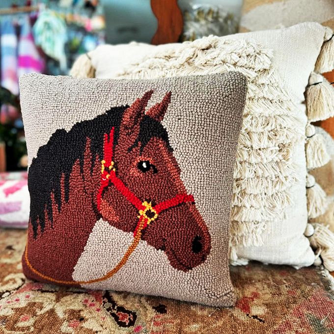 Giddy up your decor! This charming horse pillow adds a touch of rustic charm to any couch, perfect for those who love a bit of equestrian flair.