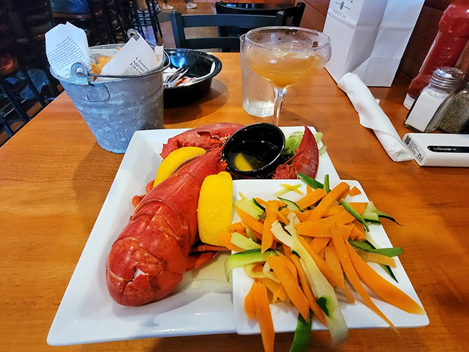 A perfectly steamed Maine lobster arrives like royalty, accompanied by its loyal subjects: fresh vegetables and drawn butter. Photo credit: J J