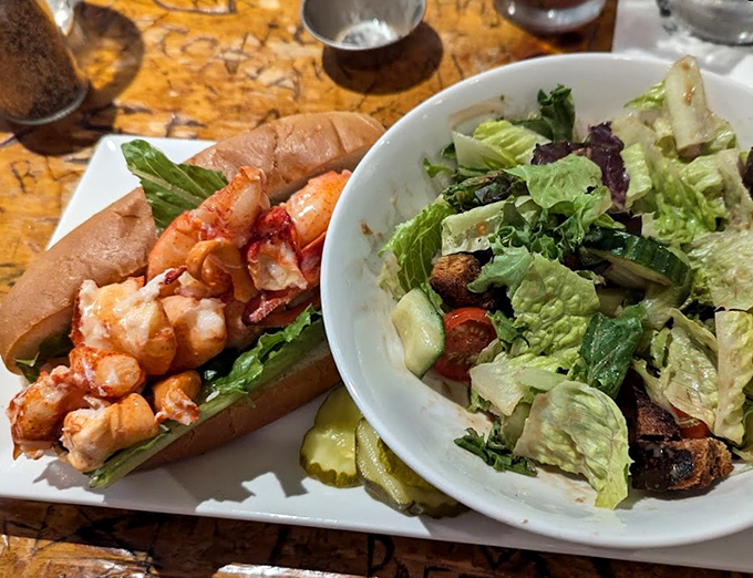 Maine's famous lobster roll, generously stuffed and perfectly dressed, with a garden-fresh salad playing backup.