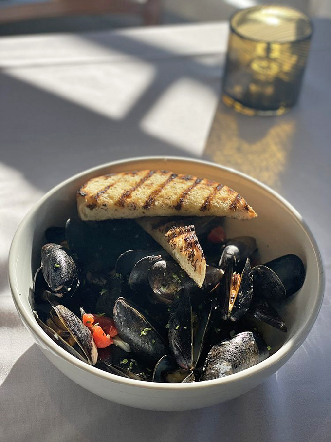 PEI mussels and grilled bread: a maritime match made in heaven, perfect for soaking up every drop of broth. Photo credit: Gohar K.