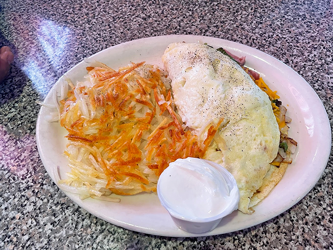 An omelet that's practically doing the jitterbug with those perfectly crispy hash browns. A breakfast worth setting your alarm for. Photo credit: Victoria Y Ray