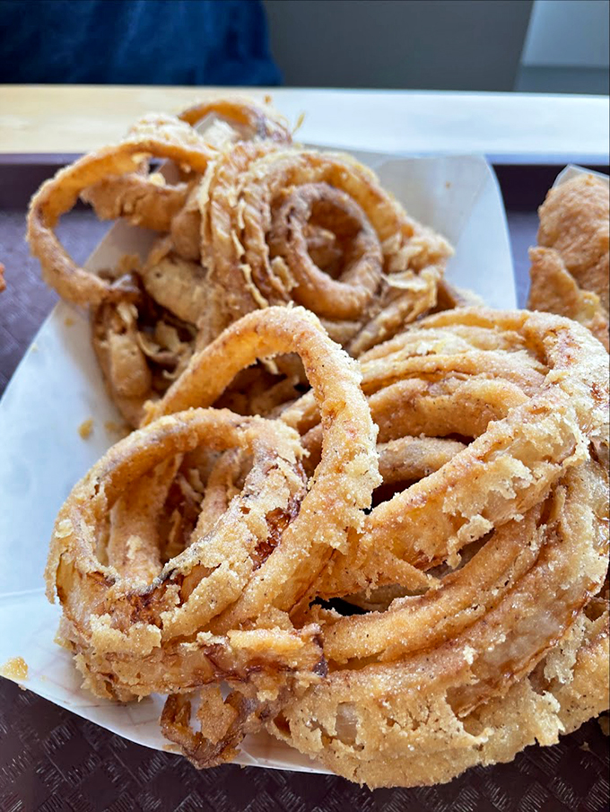 These aren't just onion rings - they're crispy halos of happiness that make regular fries jealous.