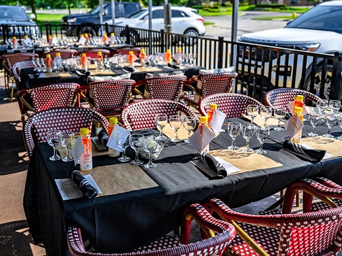 Red and white bistro chairs invite al fresco dining with a touch of Parisian charm, right here in Clinton Township.