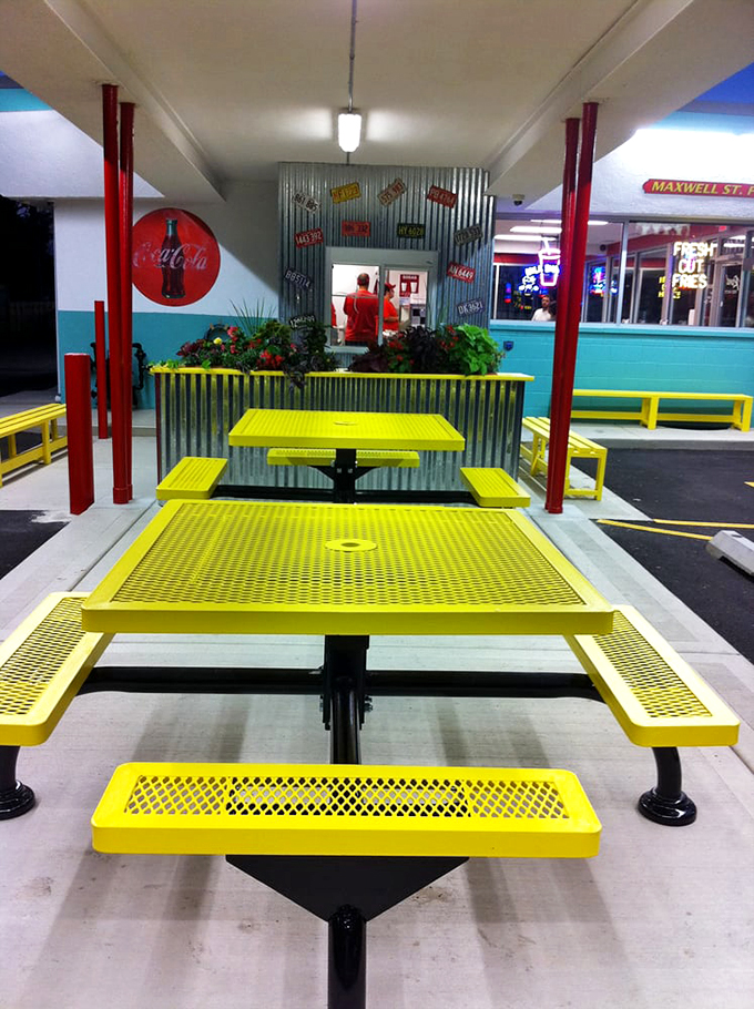 Yellow picnic tables under turquoise trim create the perfect stage for summer memories and mustard-stained conversations.
