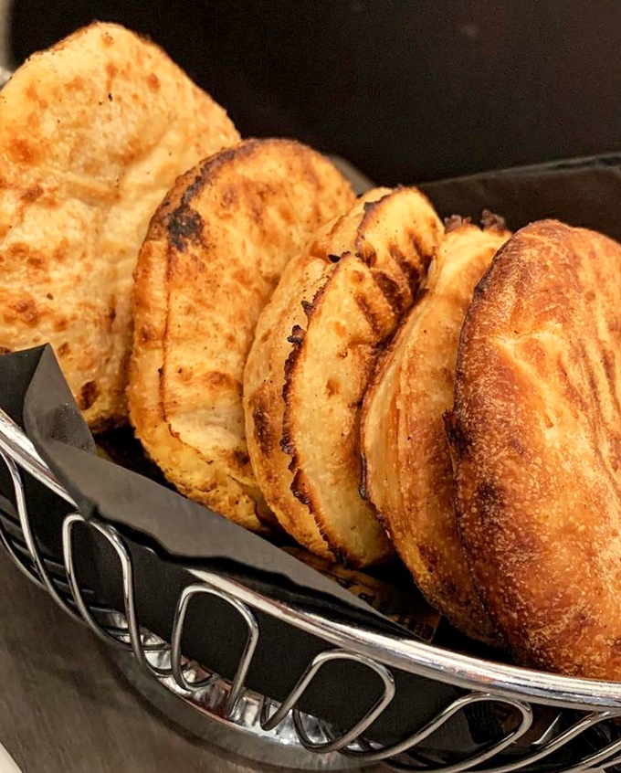 Golden-brown pita slices lined up like delicious dominos, ready to start a chain reaction of happy dining moments.