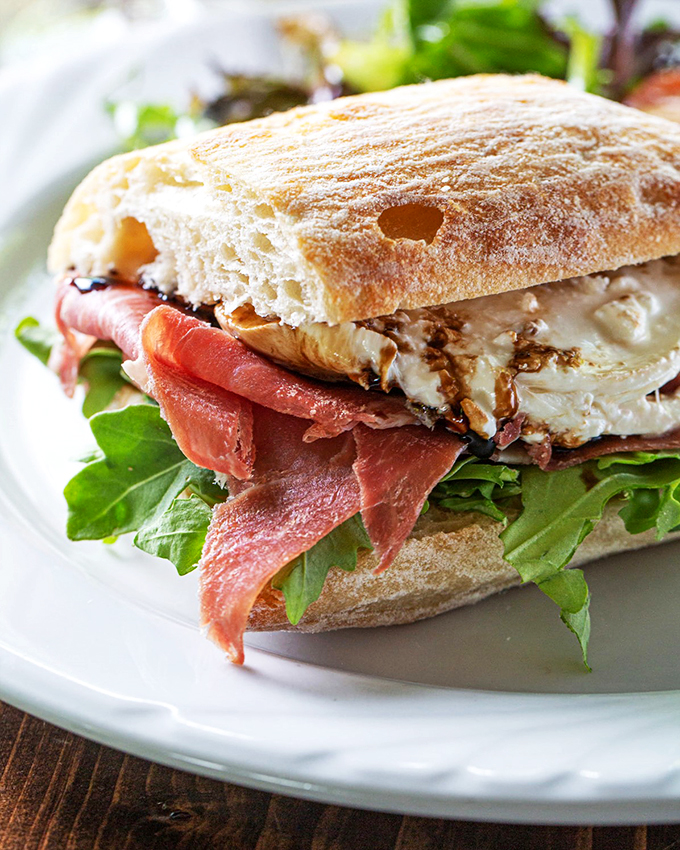 Prosciutto so thin you could read the newspaper through it, paired with fresh greens and creamy mozzarella.