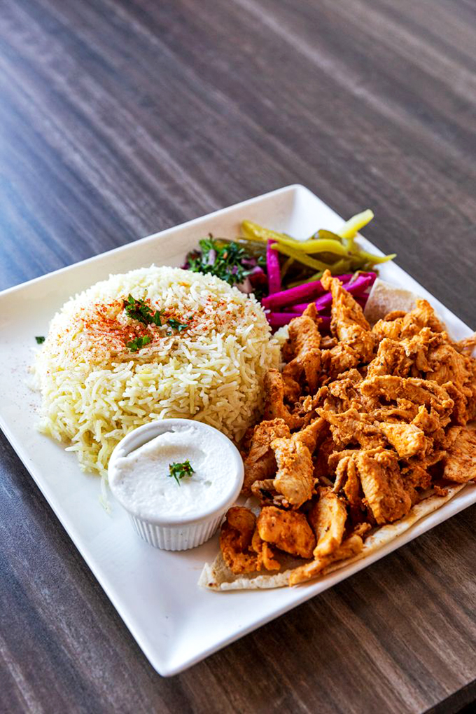 Tender chicken shawarma meets perfectly seasoned rice in a plate that's both comfort food and culinary artistry.