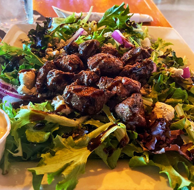 Tender steak bites lounging on fresh greens - because sometimes salads deserve to wear their Sunday best.