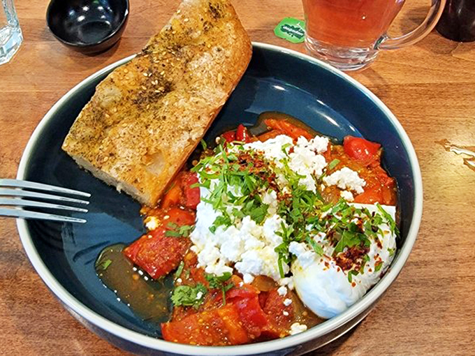 A symphony of tomatoes and eggs, topped with feta that melts like little clouds in a savory sunset.