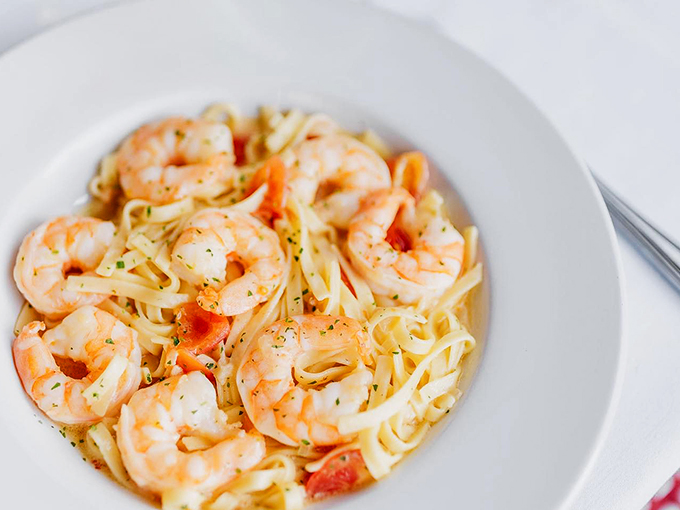 Plump shrimp play hide-and-seek among ribbons of pasta, each bite a perfect balance of land and sea. Photo credit: Nick's Steakhouse