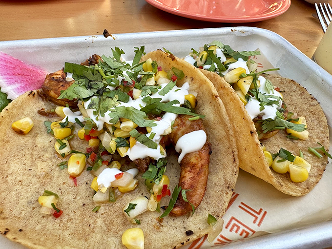 Sweet corn and fresh herbs dance atop these tacos like confetti at a flavor fiesta. Photo credit: BETTY Rodriguez
